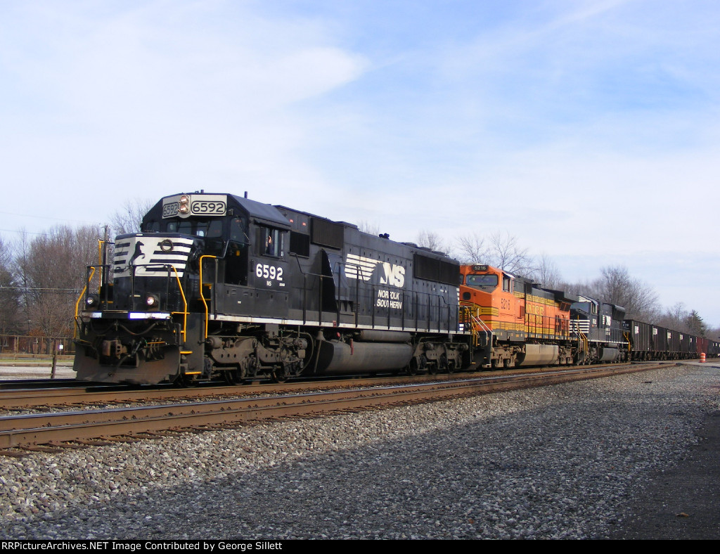 NS 6592 with BNSF 5216 blasts west with a coal train.